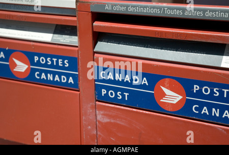 Canada Post mail worker, letter carrier delivering lettermail at a ...