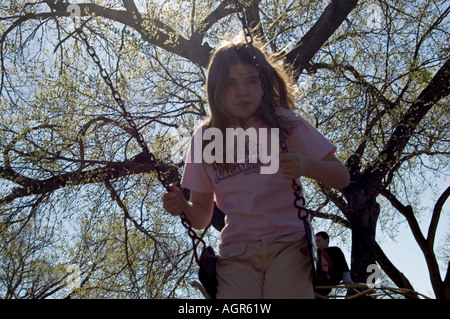 children girl swinging in a tree trunk in a pine forest Stock Photo - Alamy