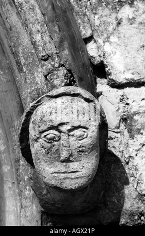 Mediaeval figure stone head on the hood mould of the window of Frensham ...