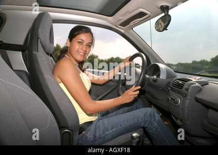 Young woman driving car looking at camera with a happy expression Stock ...