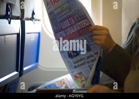 Man on an Airplane reading an Inflight Magazine Stock Photo - Alamy