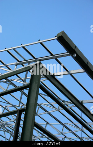skeletal frame of a partially constructed building against blue sky ...