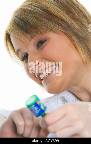 Young woman at a party pulling a party popper Stock Photo - Alamy