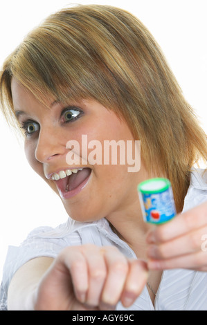 Young woman at a party pulling a party popper Stock Photo - Alamy