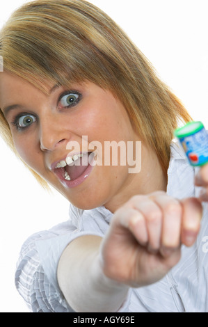 Young woman at a party pulling a party popper Stock Photo - Alamy