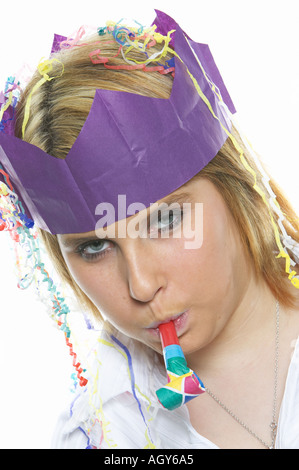 Young woman at a party pulling a party popper Stock Photo - Alamy
