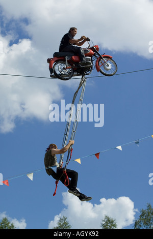 motorcycle driver balancing on rope Stock Photo - Alamy