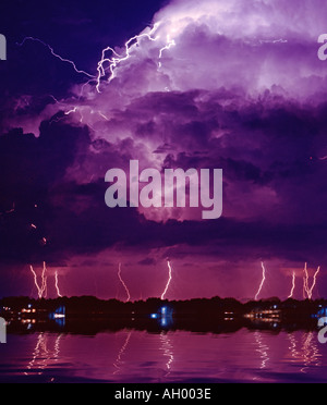 multiple lightning strikes reflected in water Stock Photo - Alamy