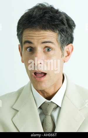 cropped shot of businessman with opened mouth in suit holding doner ...