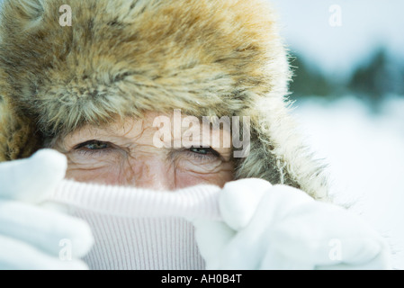 A young woman pulling a turtleneck over her head Stock Photo - Alamy