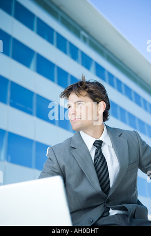 Young executive man using his laptop in the office Stock Photo - Alamy