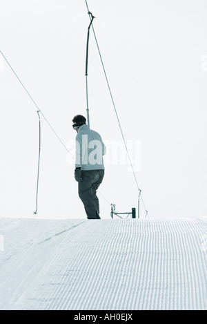 Back view of a man riding the lift on the slopes Stock Photo - Alamy