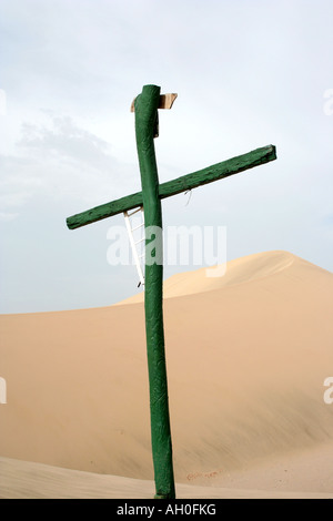 Lonely cross standing in the middle of the desert in Peru Nothing else ...