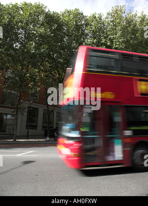 Iconic red London bus speeding through the city Stock Photo - Alamy