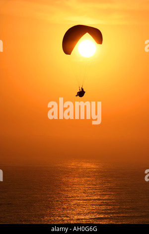 Amazing paragliding in sunset Stock Photo - Alamy