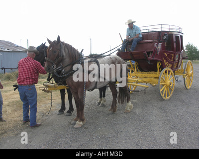 Horse drawn red stagecoach with yellow wheels Stock Photo - Alamy