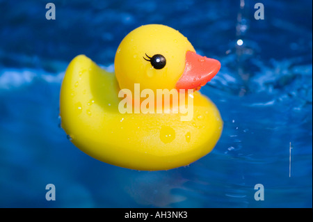 yellow plastic toy ducks falling down a waterfall and into the surge on ...
