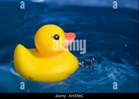 yellow plastic toy ducks falling down a waterfall and into the surge on ...