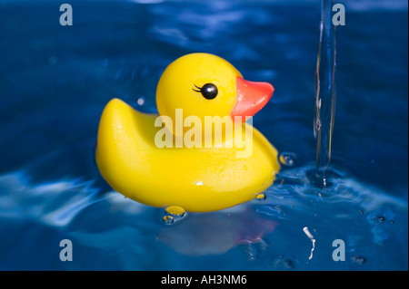 yellow plastic toy ducks falling down a waterfall and into the surge on ...