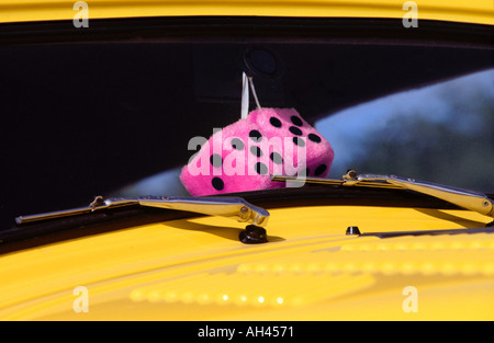 fluffy furry dice in car window Stock Photo - Alamy