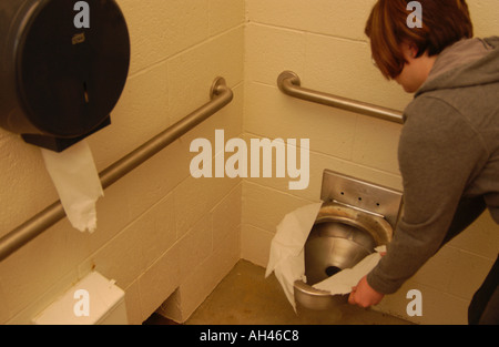 Girl in public bathroom flushing the toilet Stock Photo - Alamy