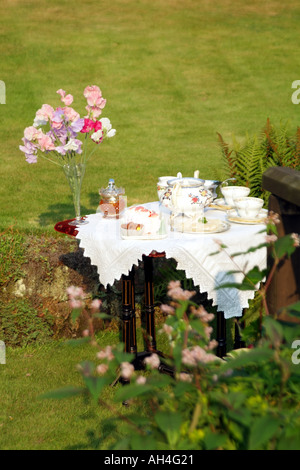 afternoon tea set on the lawn in English country garden Stock Photo - Alamy
