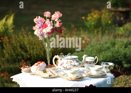 afternoon tea set on the lawn outside summer house in English country ...
