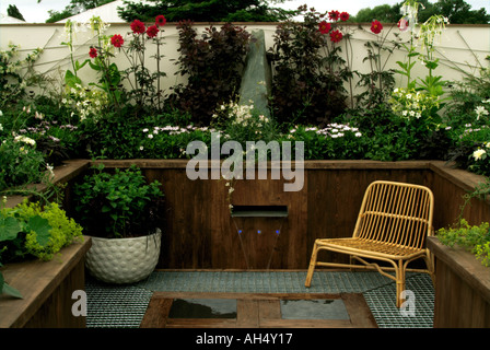 Garden seating area surrounded by raised beds and water feature Stock ...