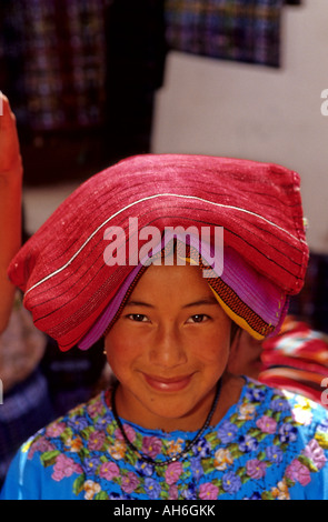 An indigenous K'iche' (Quiché) Maya woman and her daughter selling food ...