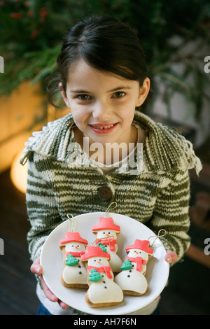 High angle view of christmas cookies in baking sheet with rolling pin ...