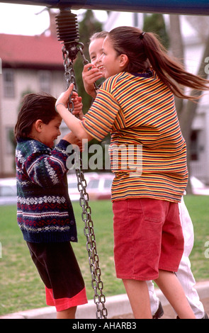 Girls swinging in a park Stock Photo - Alamy
