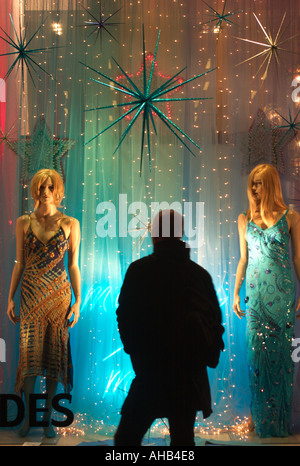 iluminated store window with showroom dummies and a consumers ...