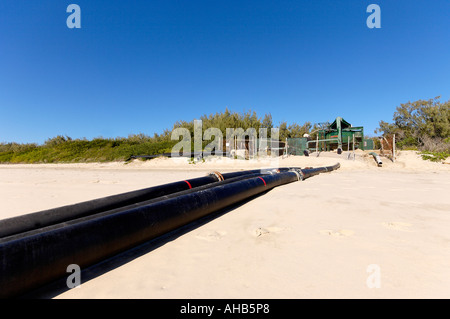 Pipes for pumping sand at the beach. The sand-pump dredger "Trael" of ...