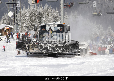 Snow plough or dameuse piste basher in snow ski resort area of Morzine ...