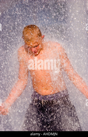 A boy plays in a water fountain at the Fundidora Park in Monterrey ...