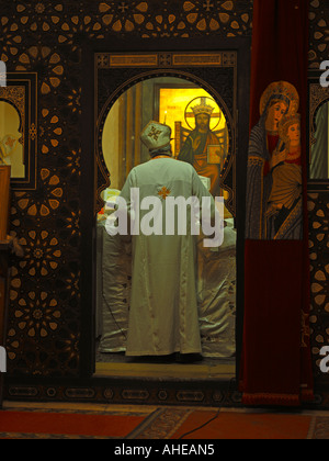 A Priest before the altar in the Hanging Church Al-Muallaqa in Cairo ...