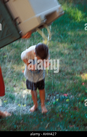 kid getting water dumped on his head Stock Photo - Alamy