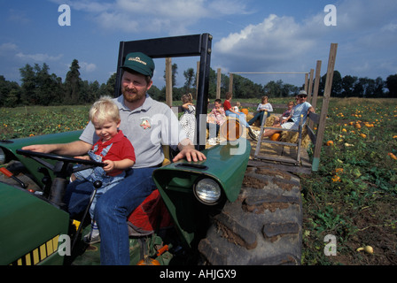 USA Maryland MR Edwin and Bennett Remsberg ride tractor at hay ride on ...
