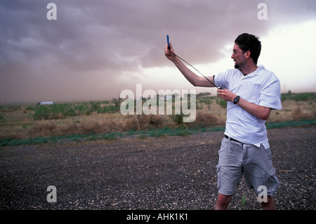 USA New Mexico Clovis Storm chaser Adam Houston uses anemometer to ...