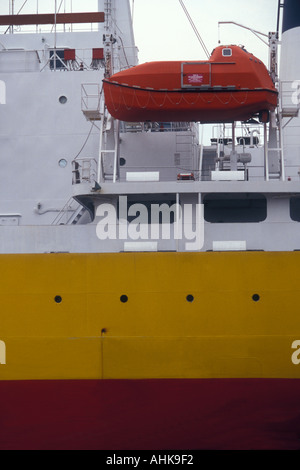 Lifeboat hanging on the ship side with frothy water underneath Stock ...