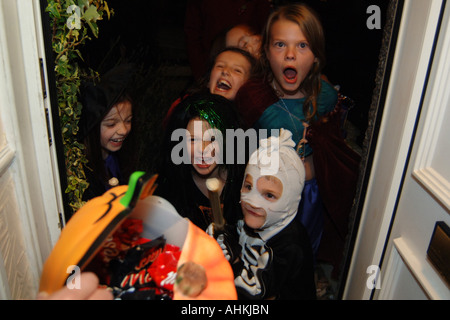 Halloween Trick or Treat children knock on doors asking for sweets or ...