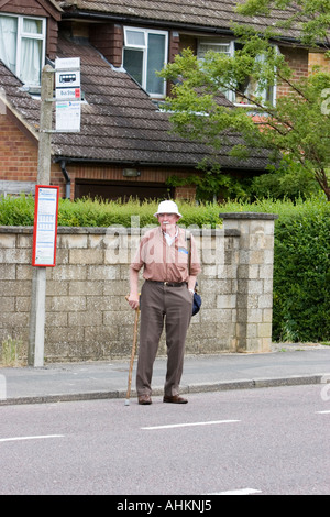 Old man waiting patiently at a bus stop Stock Photo - Alamy