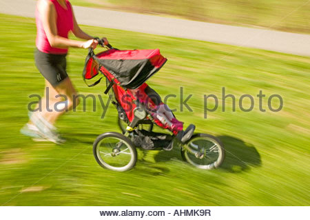 Woman running with baby stroller in park Stock Photo: 55275925 - Alamy