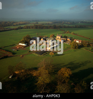 Aerial view of lone farmhouse and autumn leaves changing color in the ...
