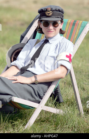 RAF at War nurse in period costume enjoys the sunshine during a WW2 ...