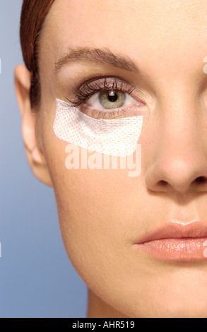 Woman wearing an adhesive plaster on face Stock Photo - Alamy
