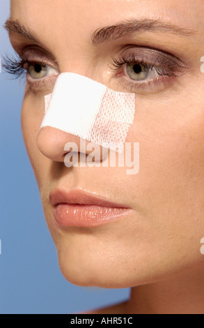 Woman wearing an adhesive plaster on face Stock Photo - Alamy
