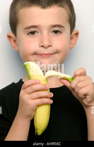 A boy peeling a banana Stock Photo - Alamy