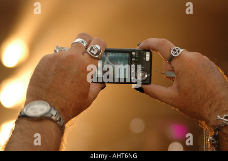 spectator taking snapshot at rock concert with digital camera Stock ...