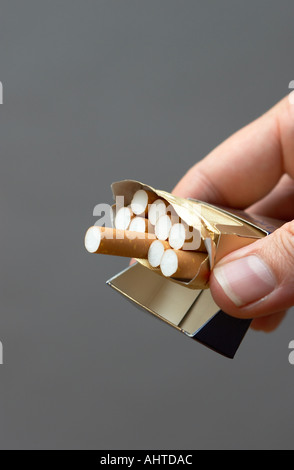 hand offering a packet of cigarettes Stock Photo - Alamy